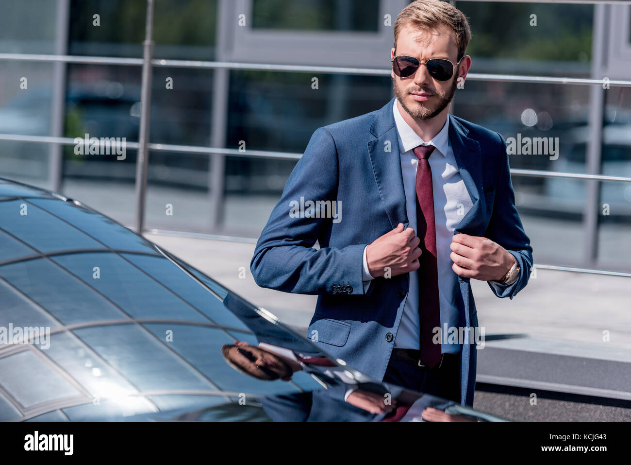businessman in suit at car Stock Photo - Alamy