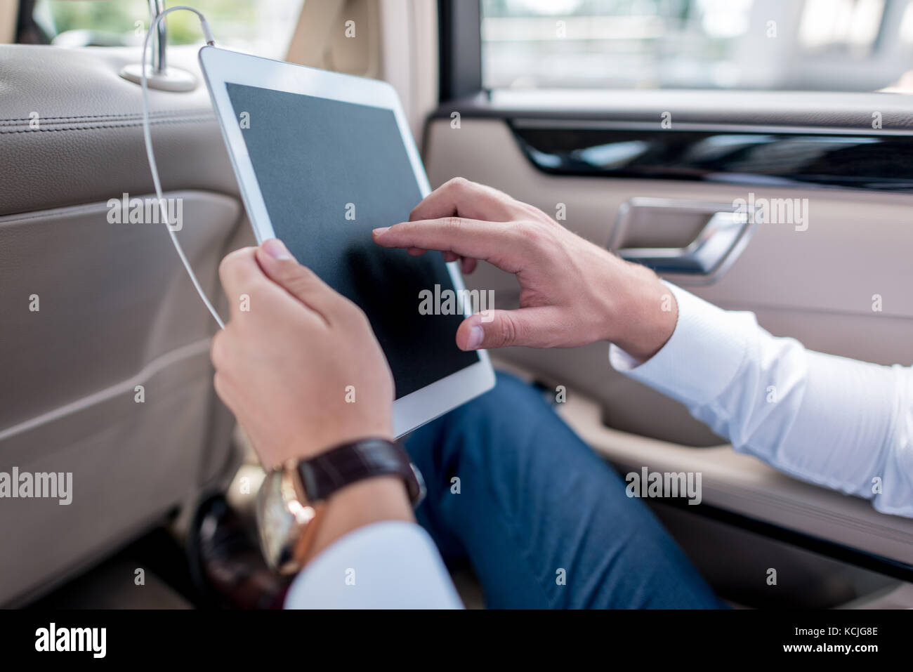 man with digital tablet in car Stock Photo - Alamy