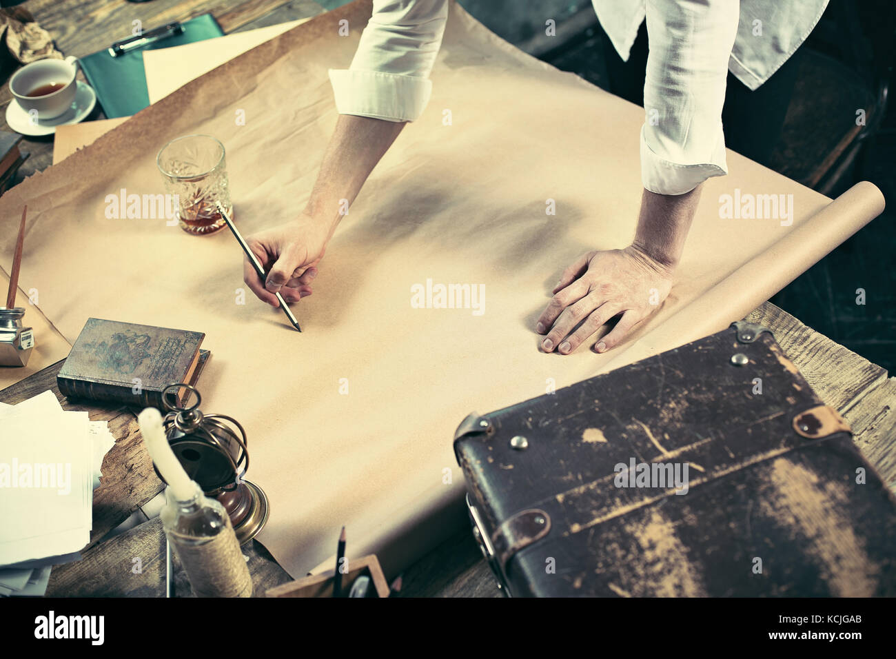 Architect working on drawing table in office Stock Photo - Alamy