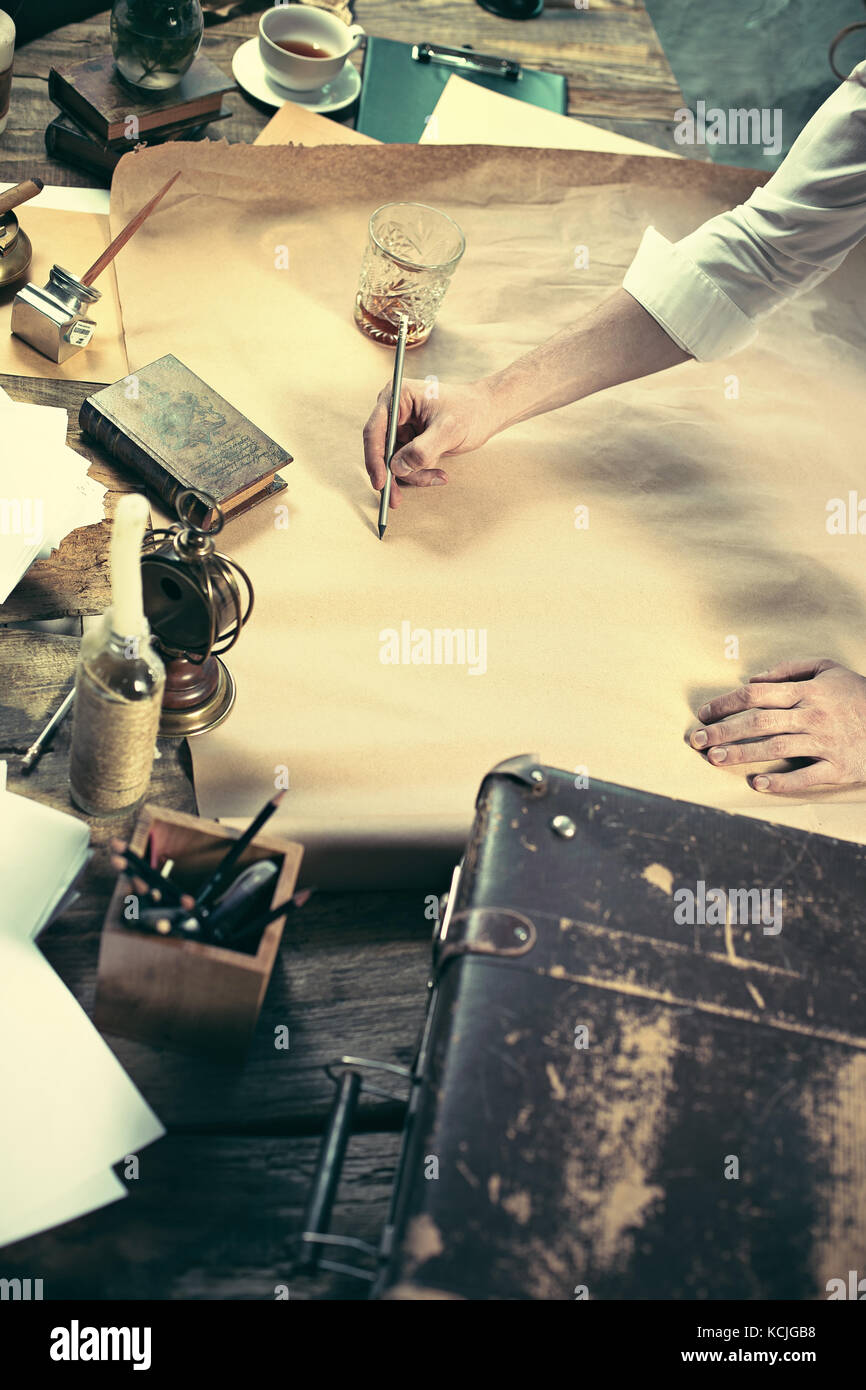 Architect working on drawing table in office Stock Photo - Alamy