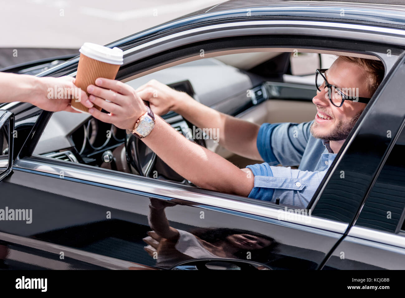 man with coffee in car Stock Photo - Alamy