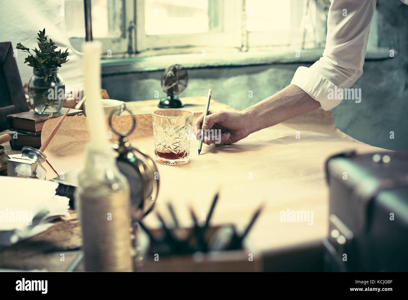 Architect working on drawing table in office Stock Photo - Alamy