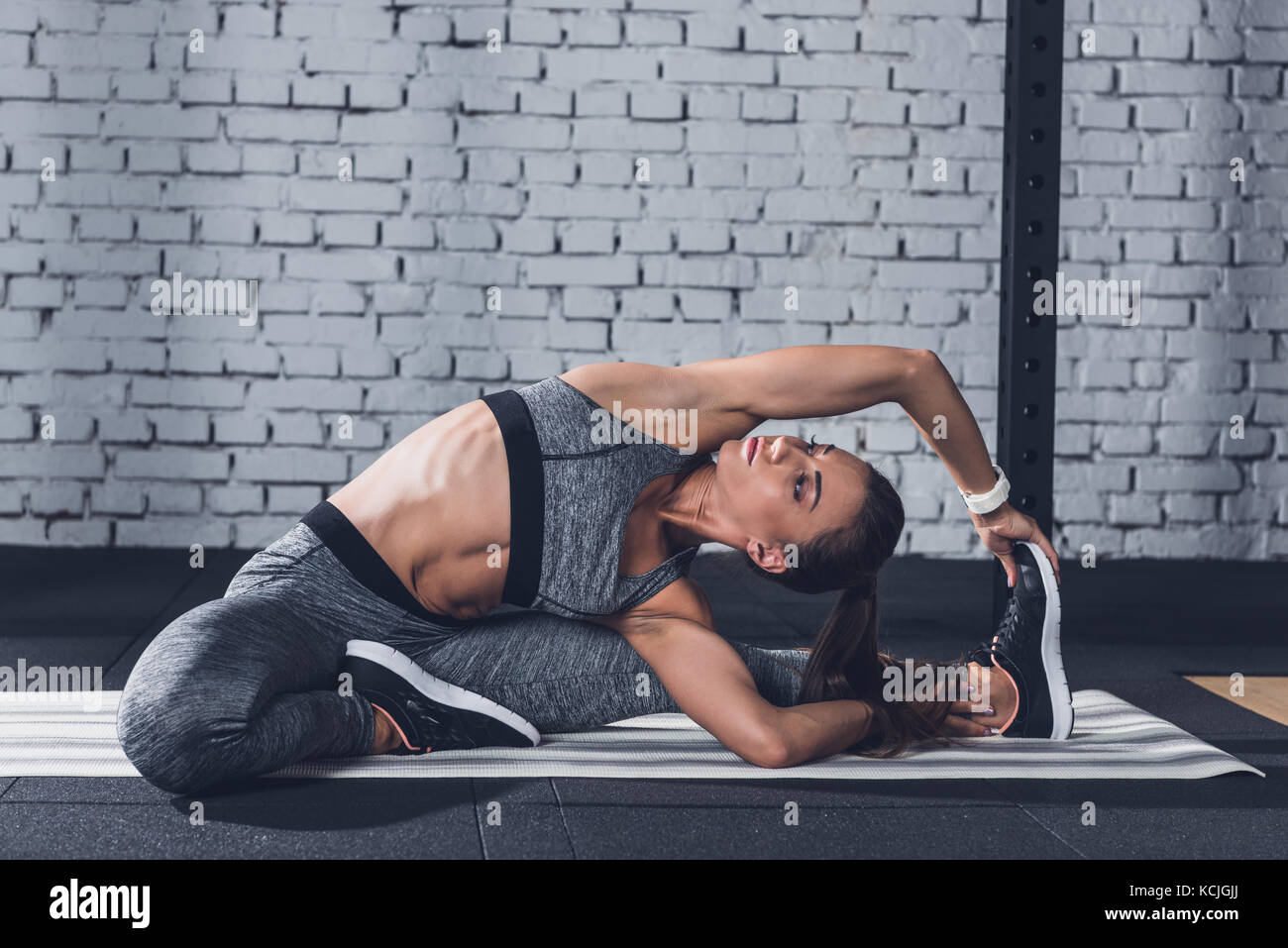 woman stretching on mat Stock Photo - Alamy