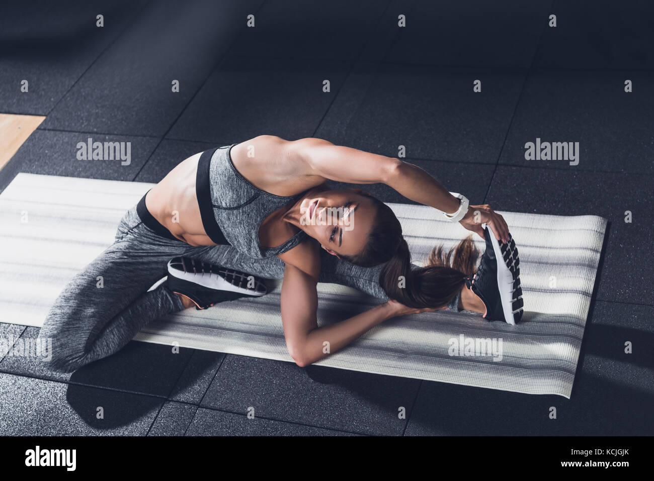 woman stretching on mat Stock Photo - Alamy