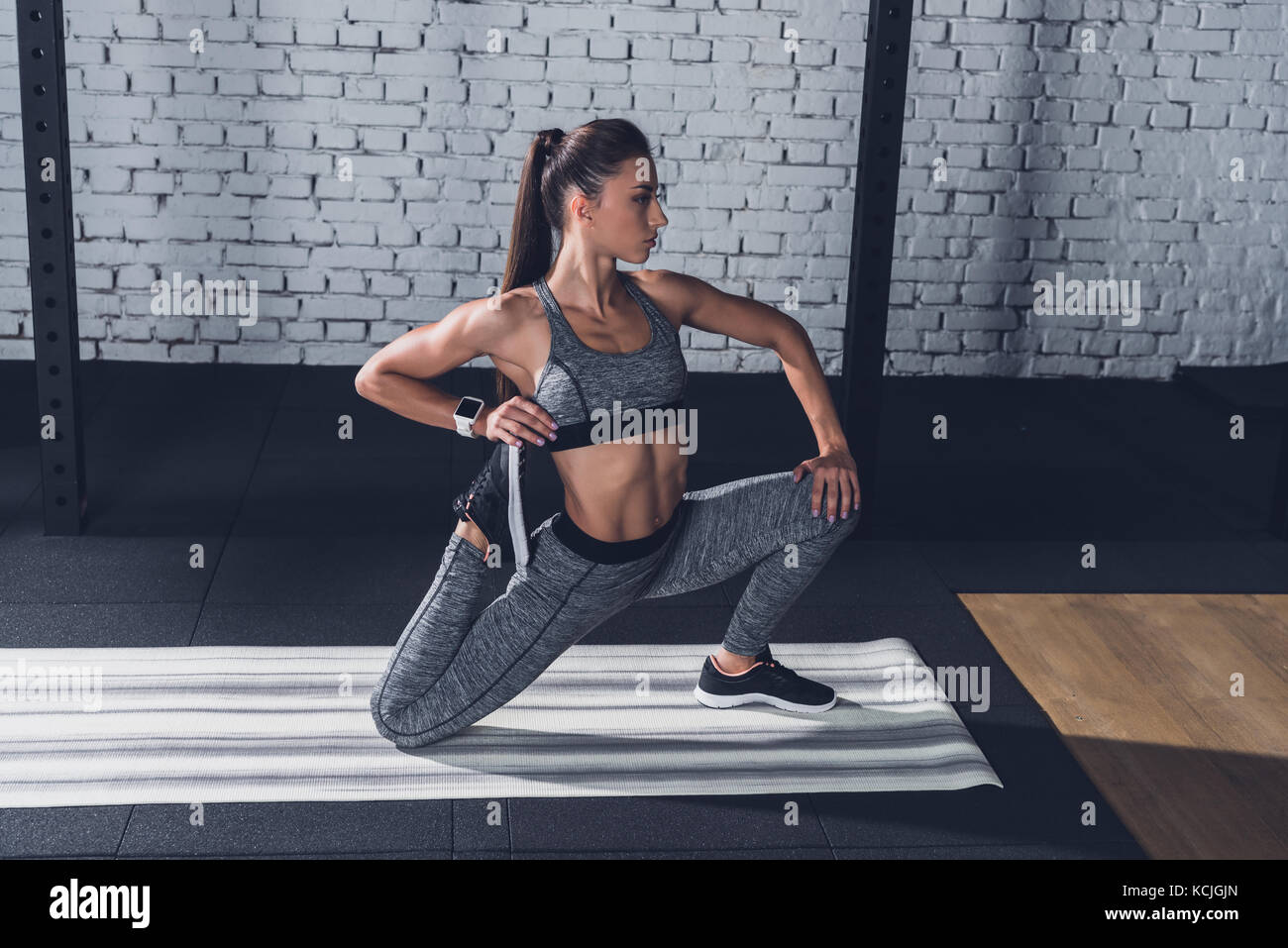 woman stretching on mat Stock Photo - Alamy