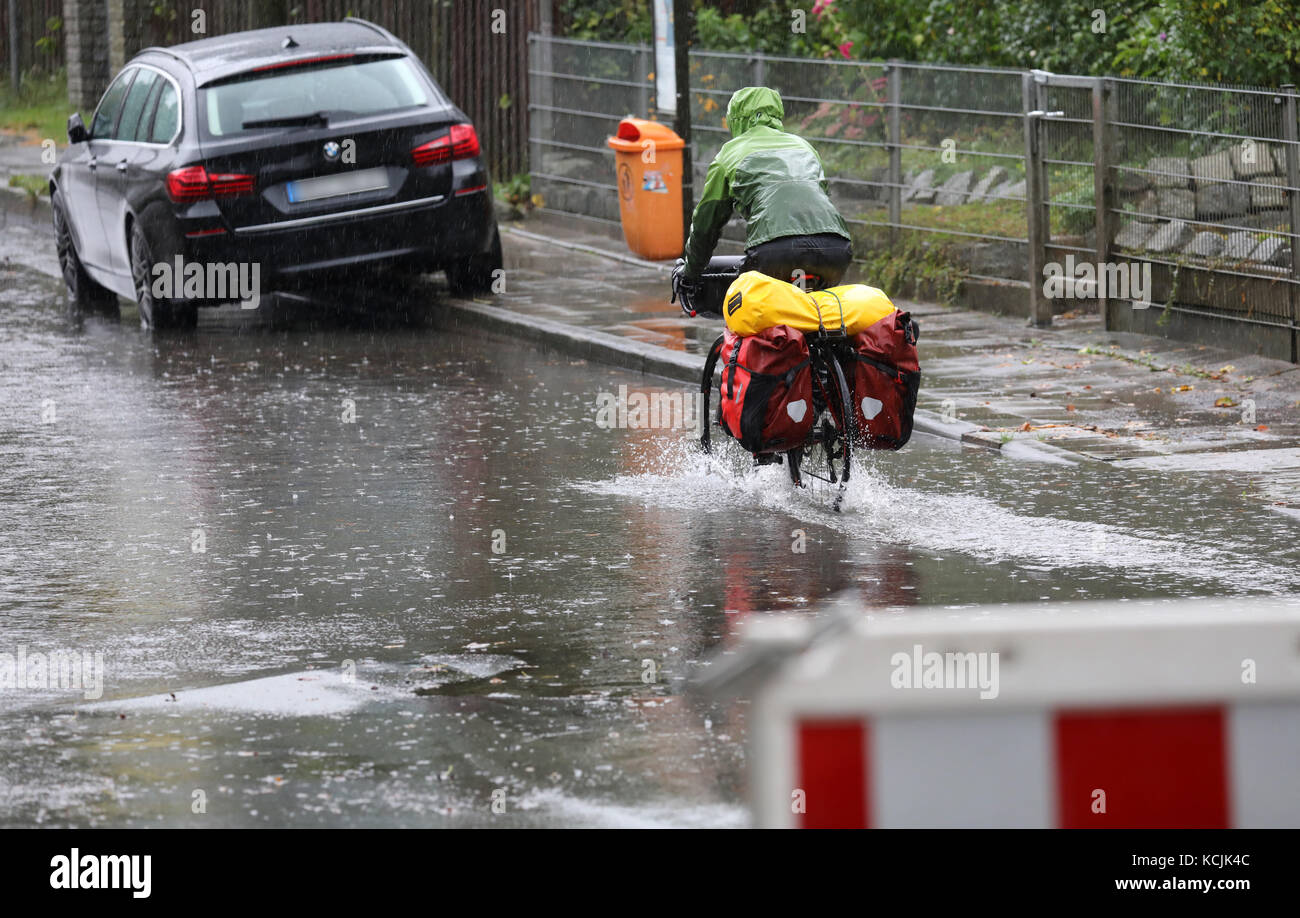 Rostock, Germany. 5th Oct, 2017. A cyclist rides on a blocked street ...