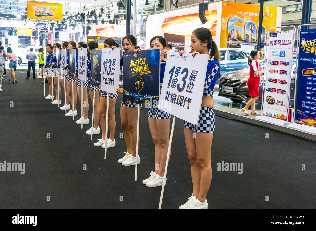 Models holding car promotional materials at 2017 Shenzhen Auto Show in ...