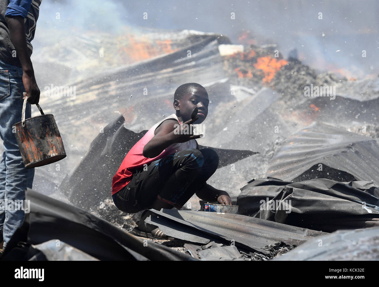 Nairobi, Kenya. 6th Oct, 2017. A boy searches for valuable things at ...