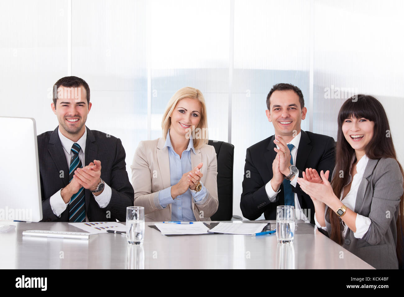 Happy Group Of Business People Clapping In Office Stock Photo - Alamy