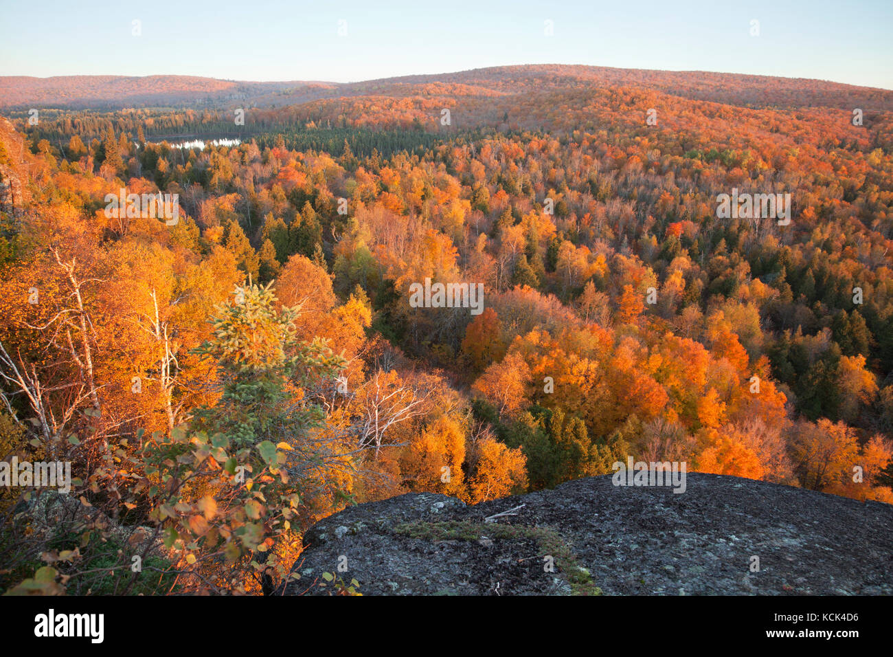 High angle view of trees in fall color with hills and lake from Oberg ...