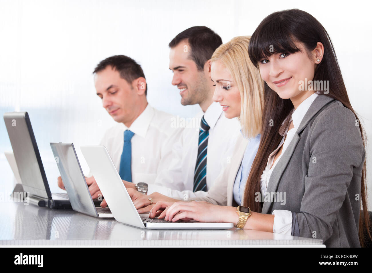 Business People Working On Laptop In Office Stock Photo - Alamy