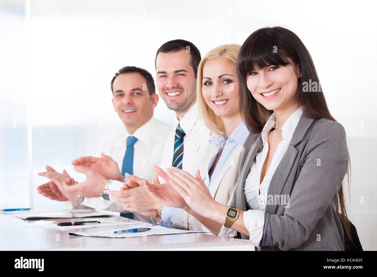 Happy Business People Clapping In The Office Stock Photo - Alamy