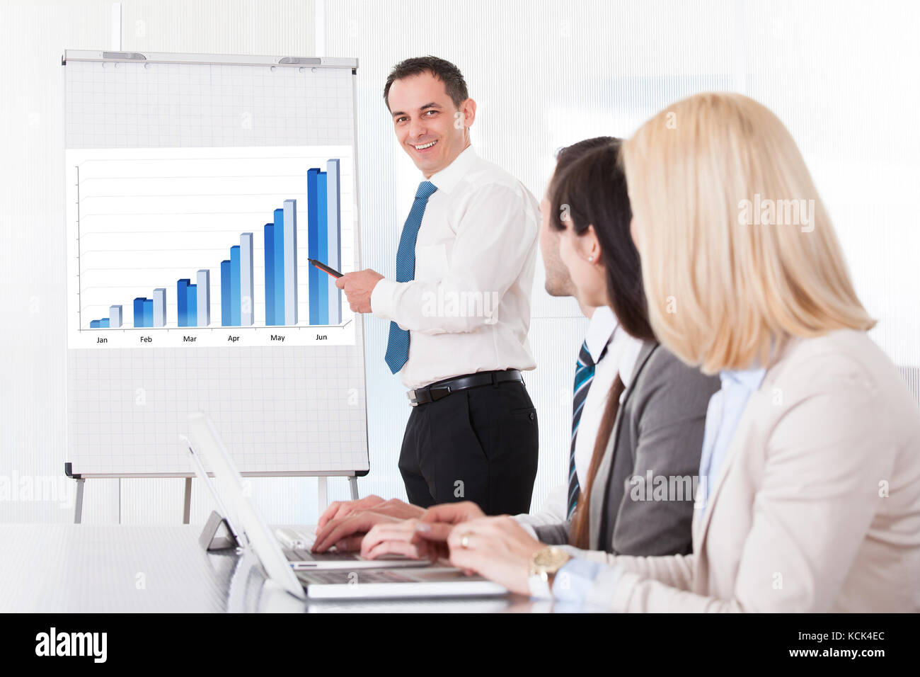 Close Up Of Business People Discussing New Project Stock Photo - Alamy