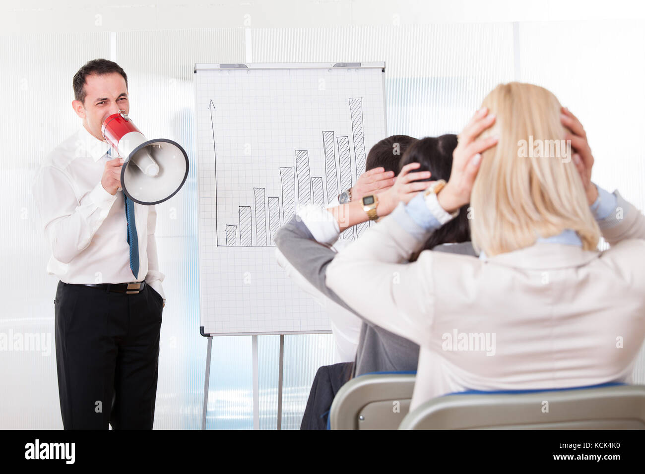 Business Man Shouting In Megaphone Indoors In Office Stock Photo - Alamy