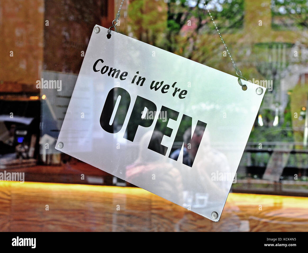 Hanging open sign in the street shop Stock Photo - Alamy