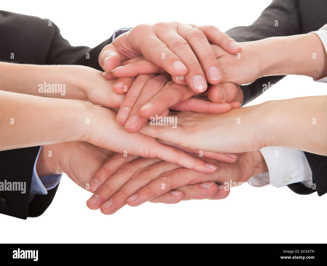 Close-up Of Businesspeople Hands Stacking Together Over White ...
