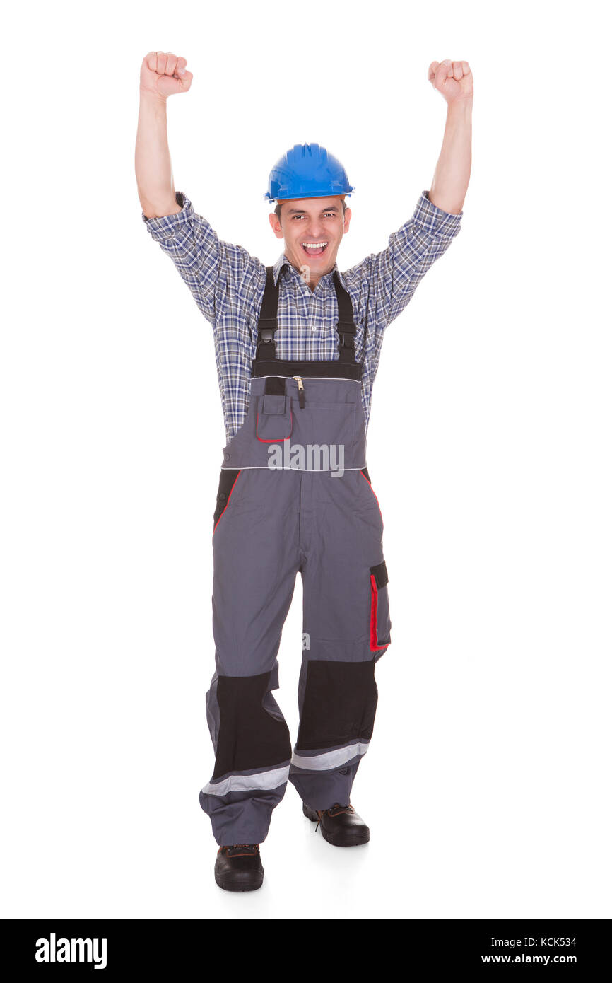 Happy Male Worker With Arm Raised Over White Background Stock Photo - Alamy
