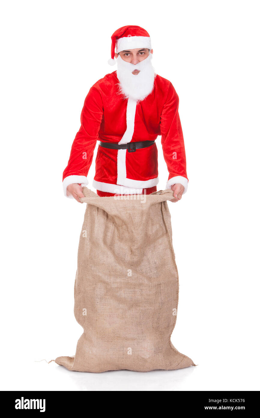 Santa Filling Bag With Gifts On White Background Stock Photo - Alamy