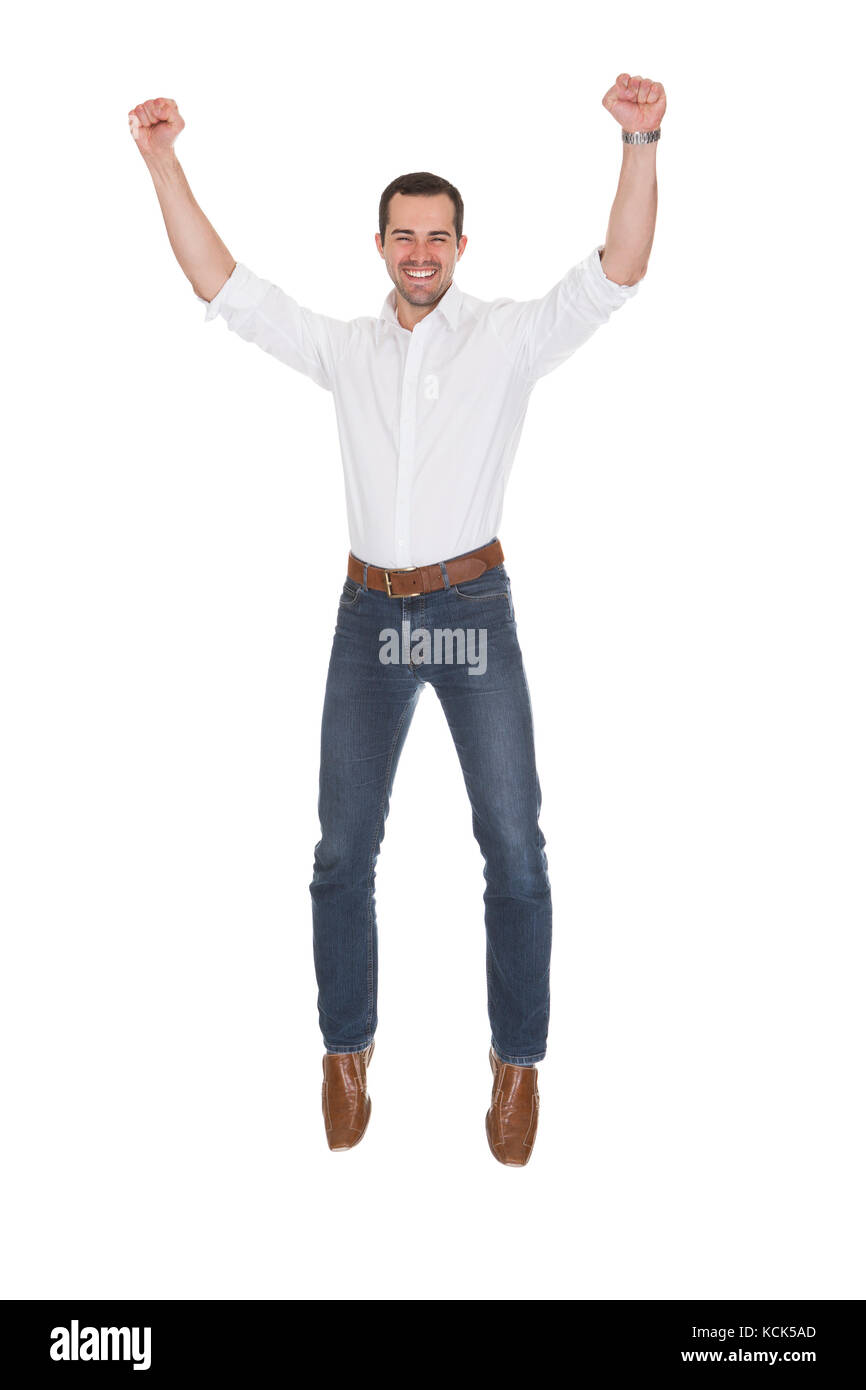 Happy Man With Arm Raised Over White Background Stock Photo - Alamy