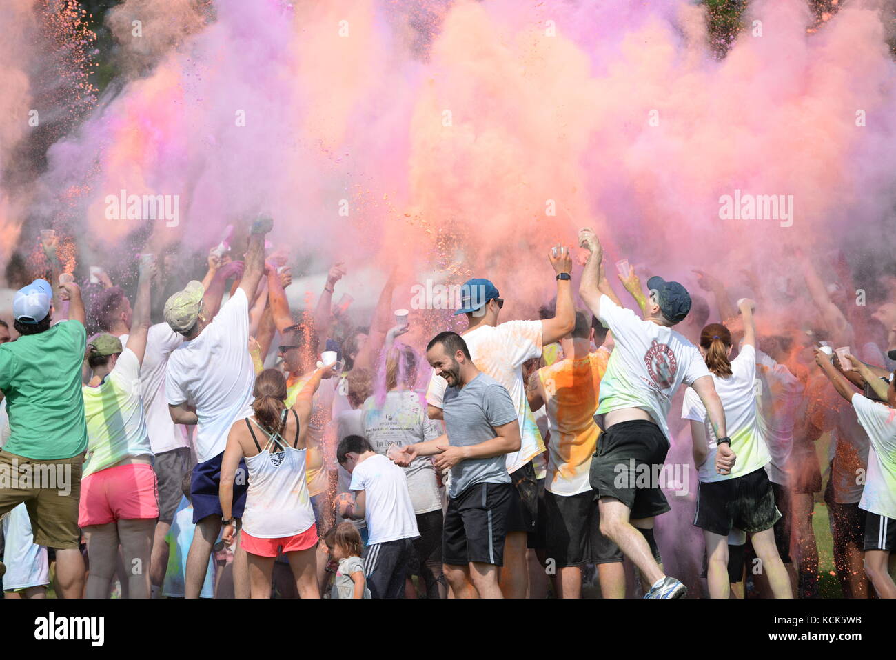Runners throw colored powder in the air during the Columbus 5K Color ...