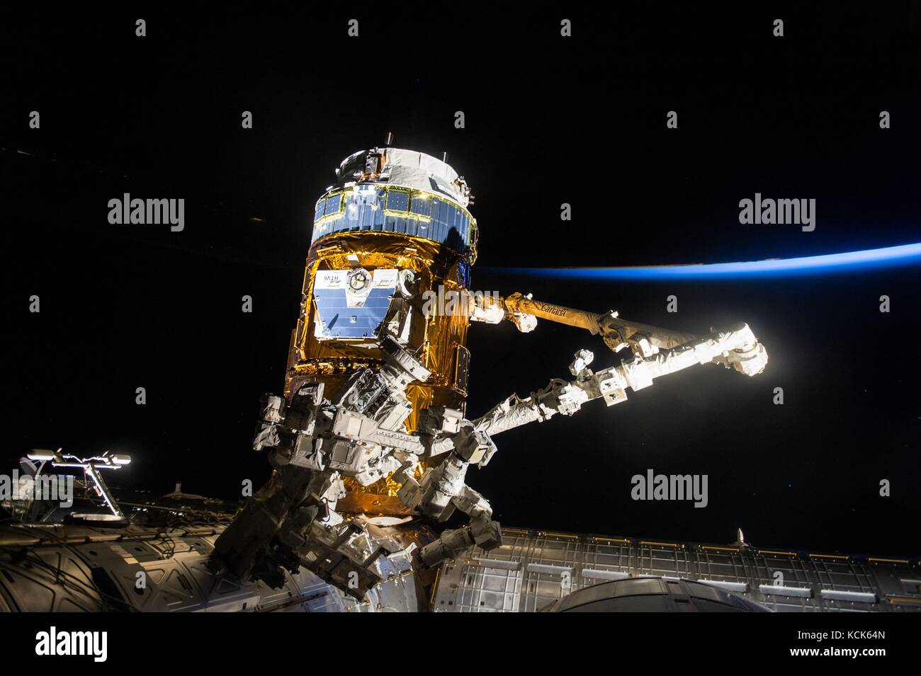 The NASA International Space Station Canadarm2 robotic arm attaches the ...