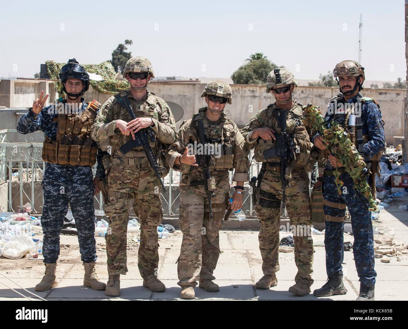 U.S. Army soldiers and Iraqi Federal Police officers pose together ...