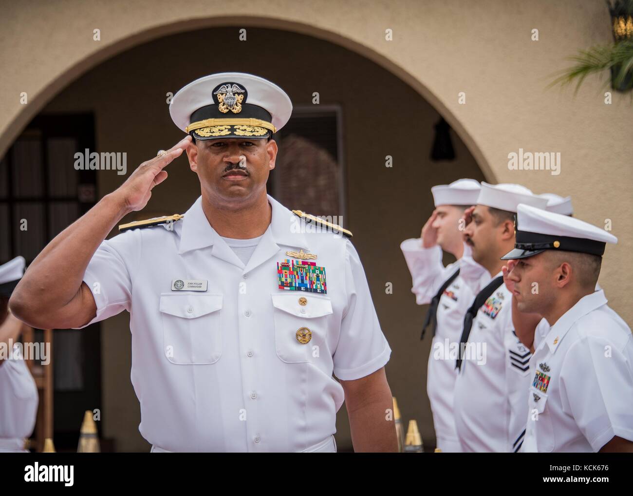 U.S. Navy Commander John Fuller salutes U.S. Navy sideboys during a ...