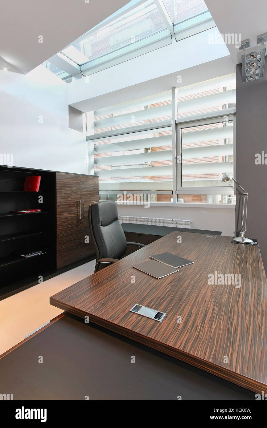 Large desk in empty modern office interior Stock Photo - Alamy
