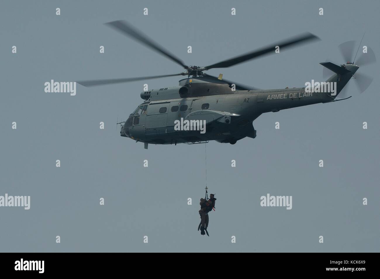 A French Air Force Aerospatiale SA 330 Puma utility helicopter hoists ...
