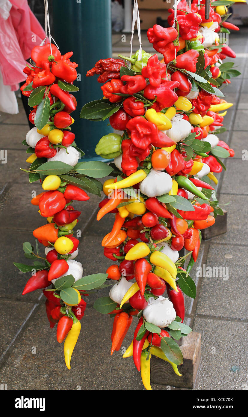 Colorful spicy peppers strings sold on market Stock Photo - Alamy
