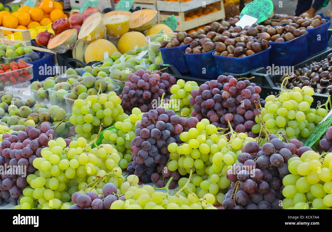 Fresh ripe grapes with other organic food on market stall Stock Photo ...