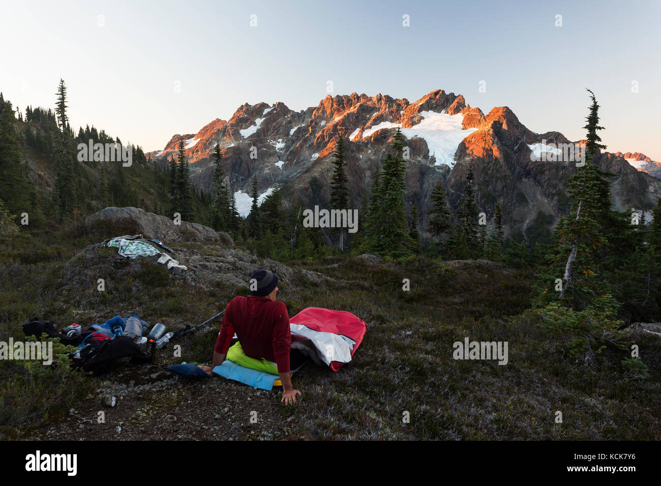 A lone hiker wakes up to early morning light scupting across the ...