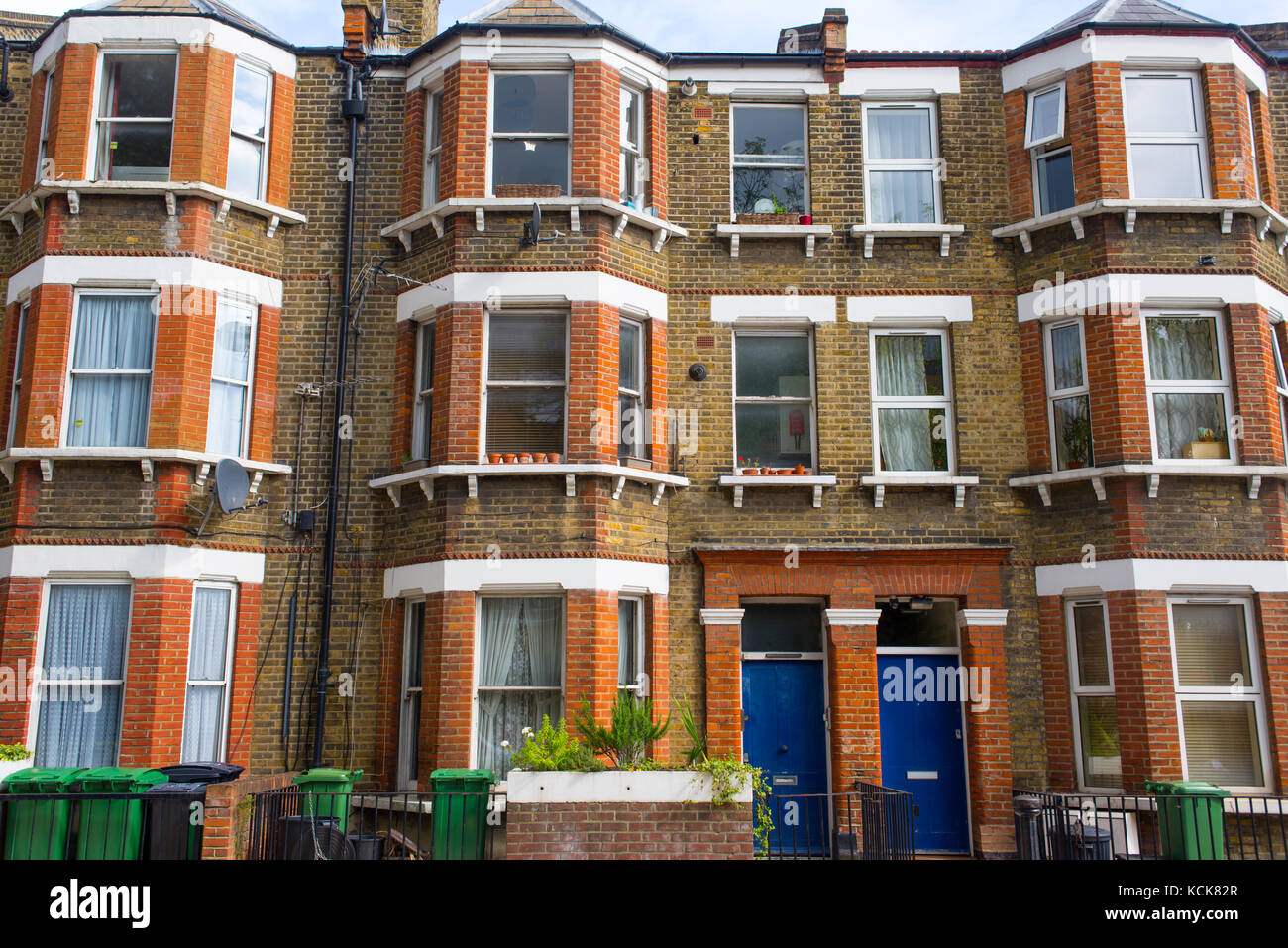 Facade of an Edwardian restored residential tenement building in red ...