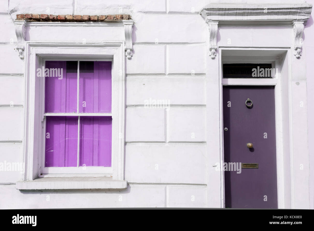 Facade of a Victorian residential building with bright violet window ...