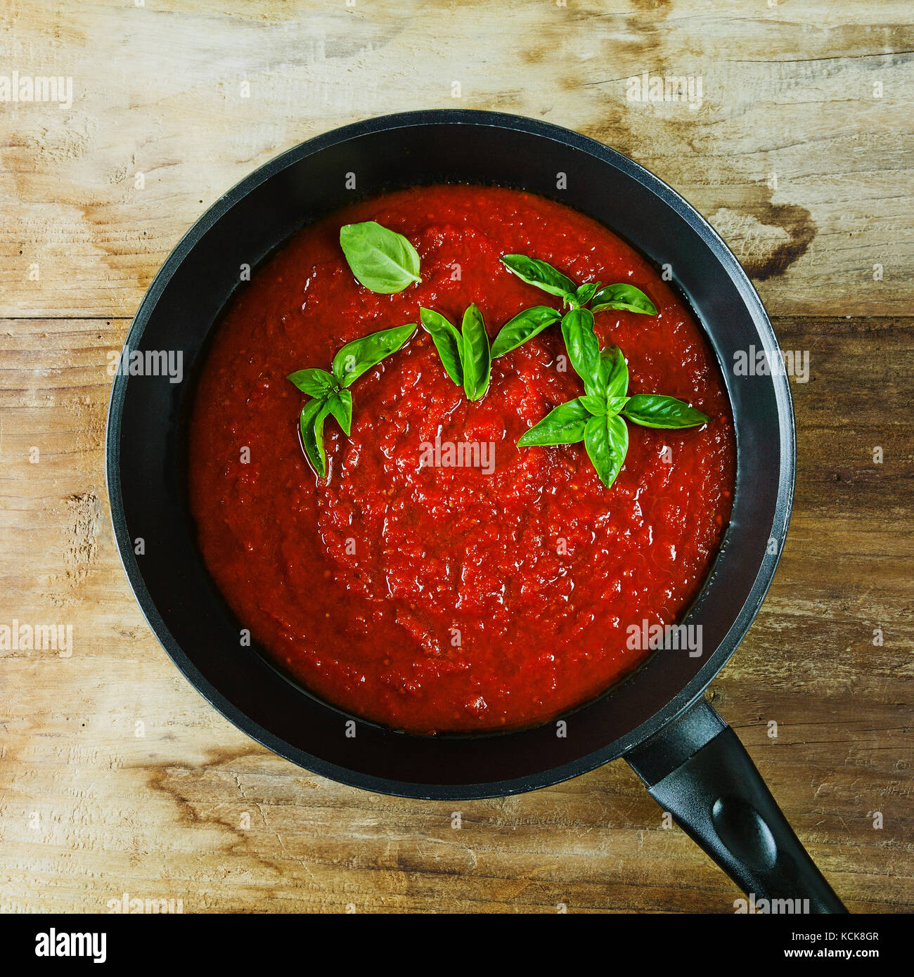 tomato sauce in a pan and fresh basil leaves Stock Photo - Alamy