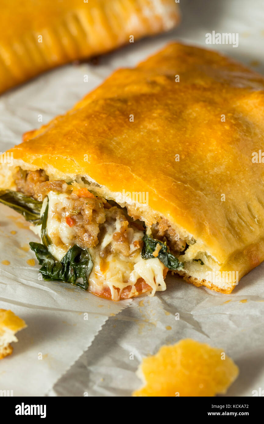 Homemade Sausage Pizza Pocket Calzone with Cheese and Marinara Stock ...