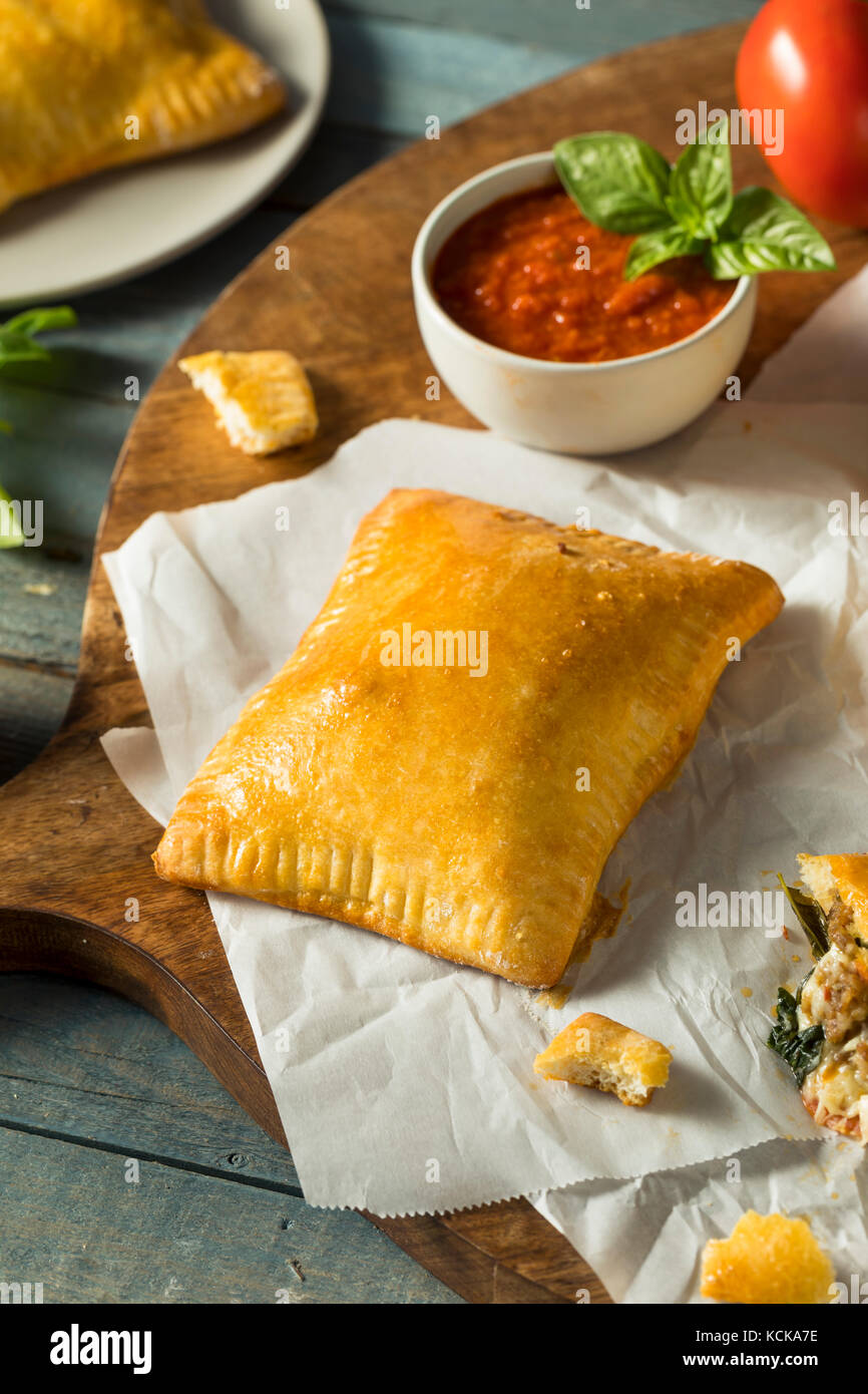 Homemade Sausage Pizza Pocket Calzone with Cheese and Marinara Stock ...