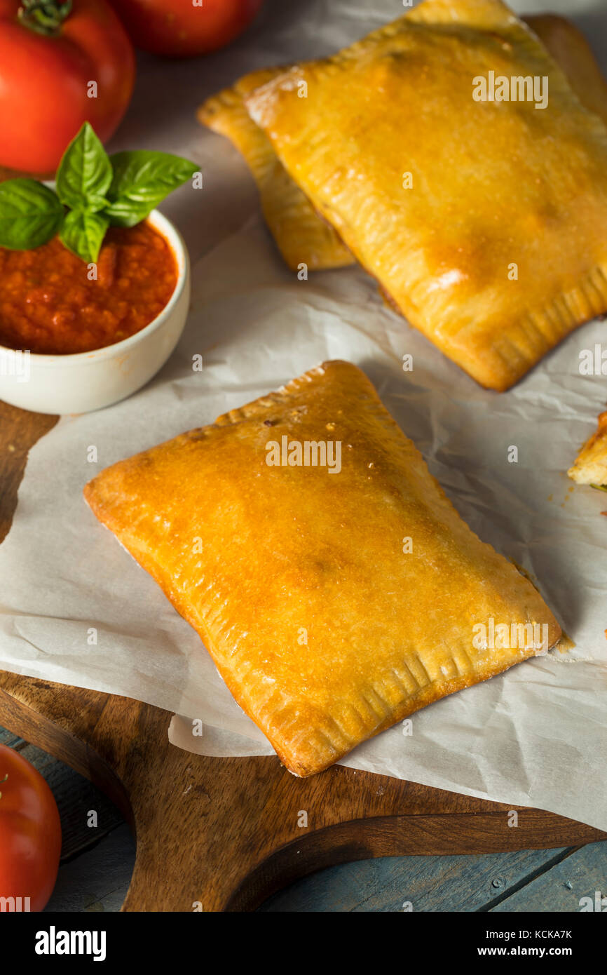 Homemade Sausage Pizza Pocket Calzone with Cheese and Marinara Stock ...