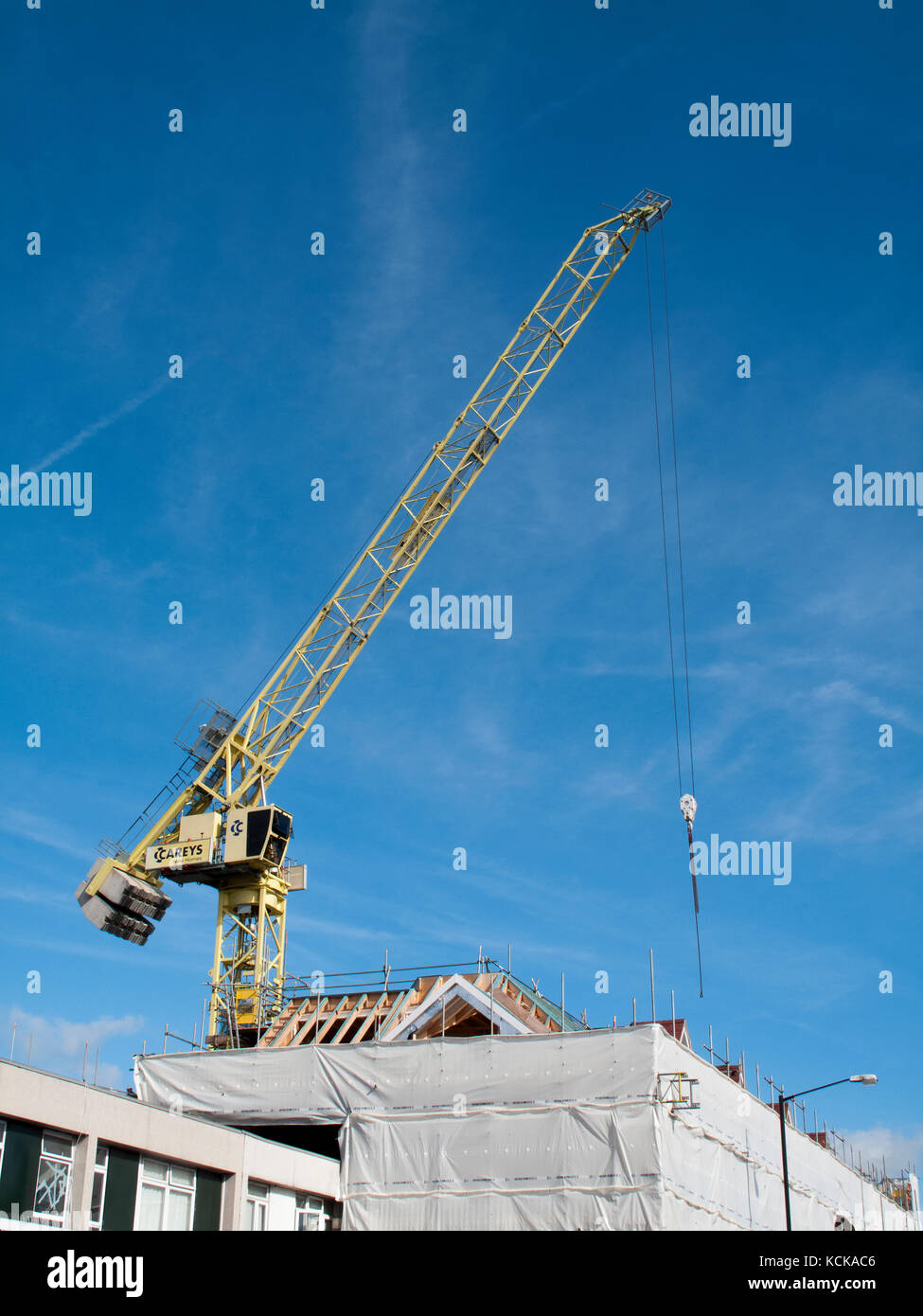 Construction site tower crane over building development Stock Photo - Alamy