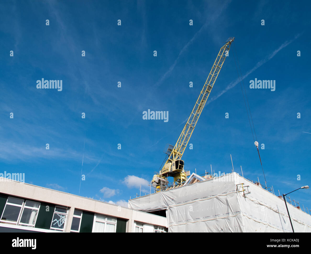 Construction site tower crane over building development Stock Photo - Alamy