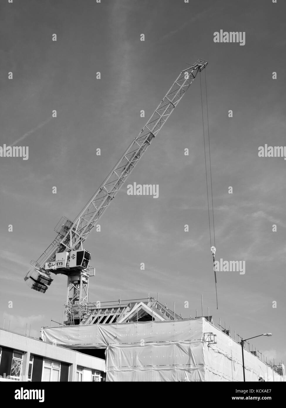 Construction site tower crane over building development Stock Photo - Alamy