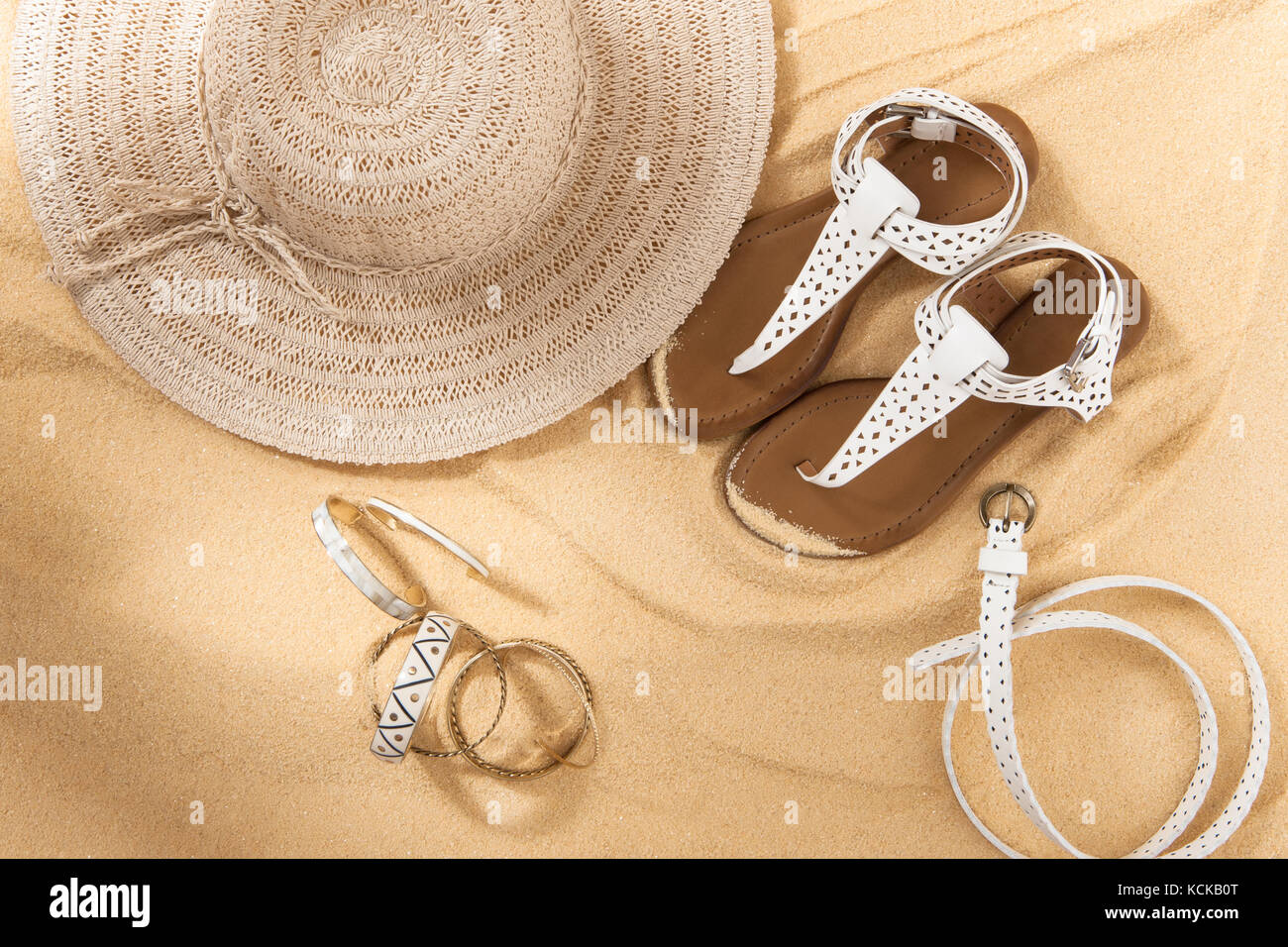 set of bright summer clothes for the beach on the golden sand Stock ...