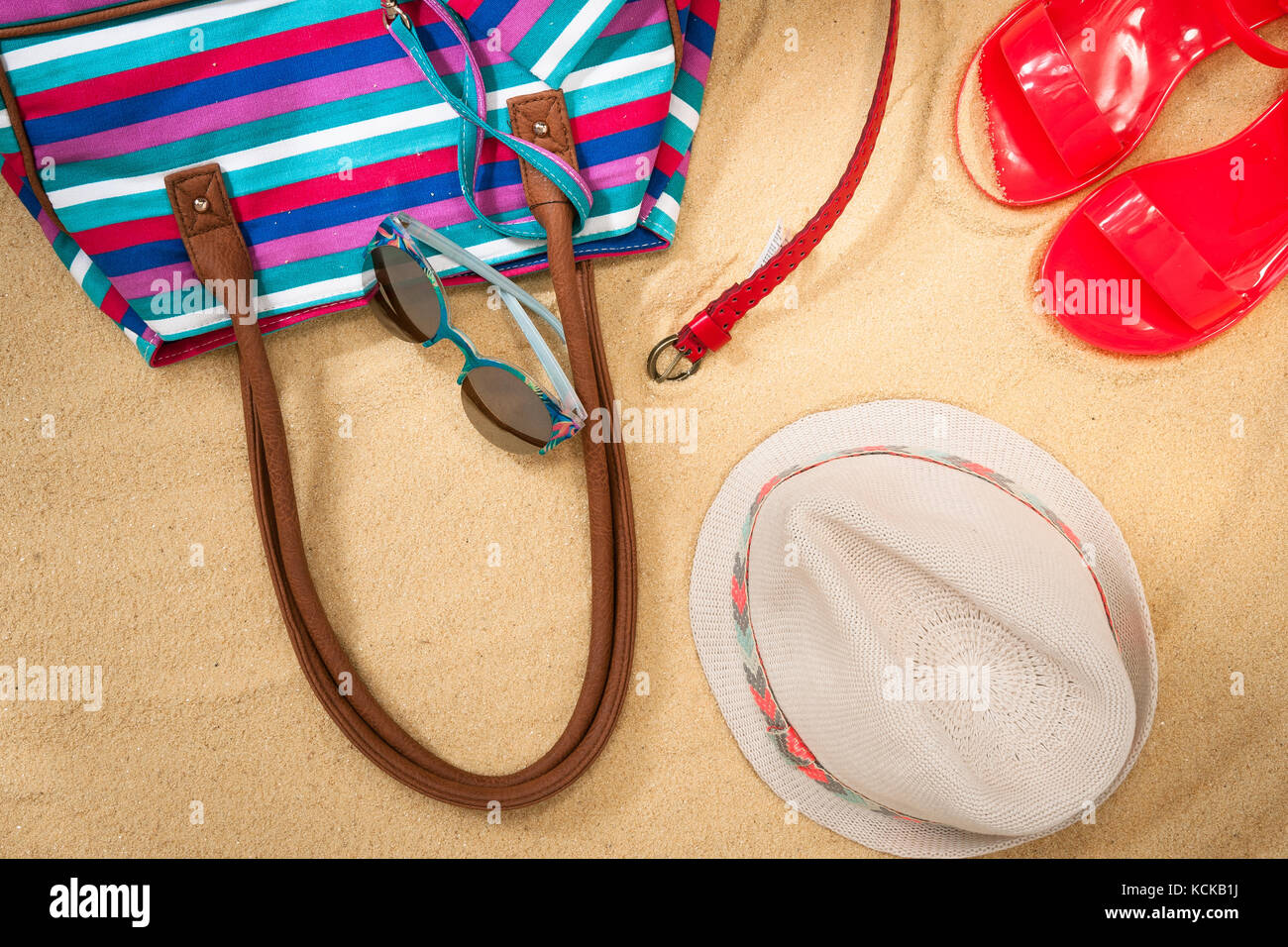set of bright summer clothes for the beach on the golden sand Stock ...