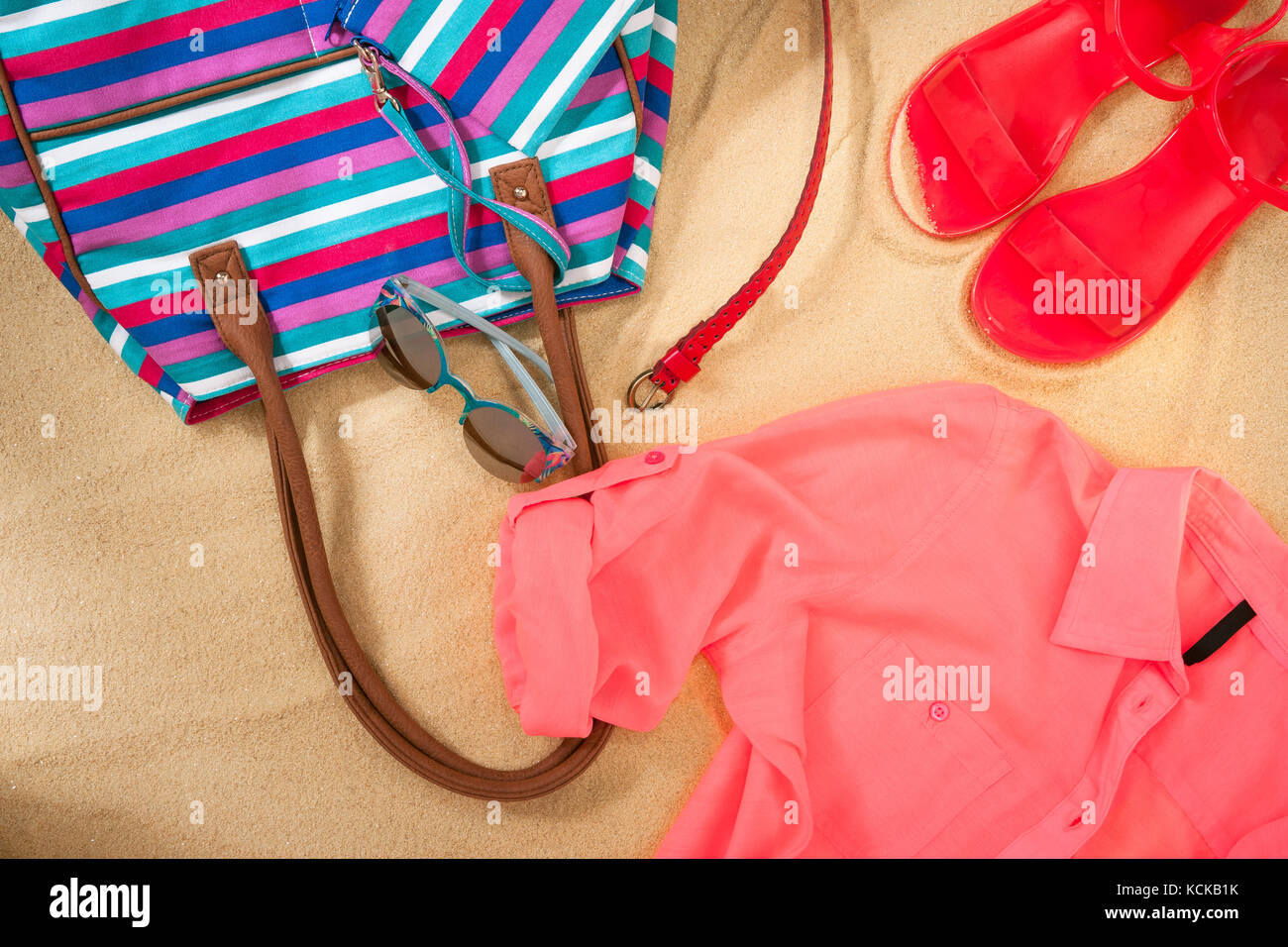 set of bright summer clothes for the beach on the golden sand Stock ...