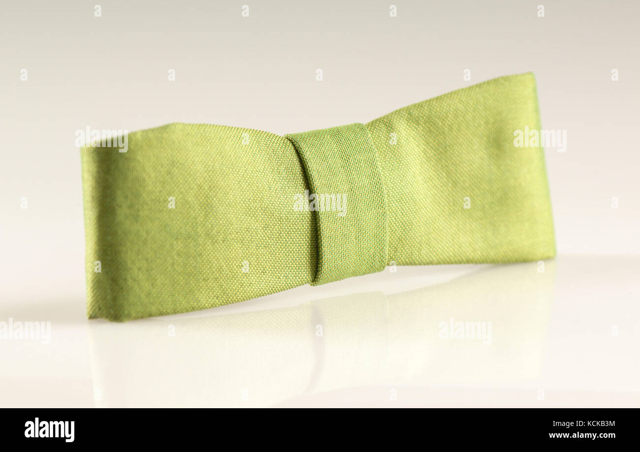 green rectangular tie-bow with reflection on a white background ...