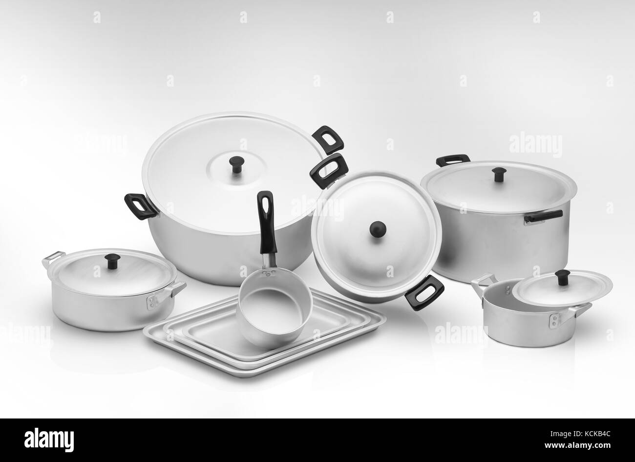 several cooking pots on a light background Stock Photo - Alamy