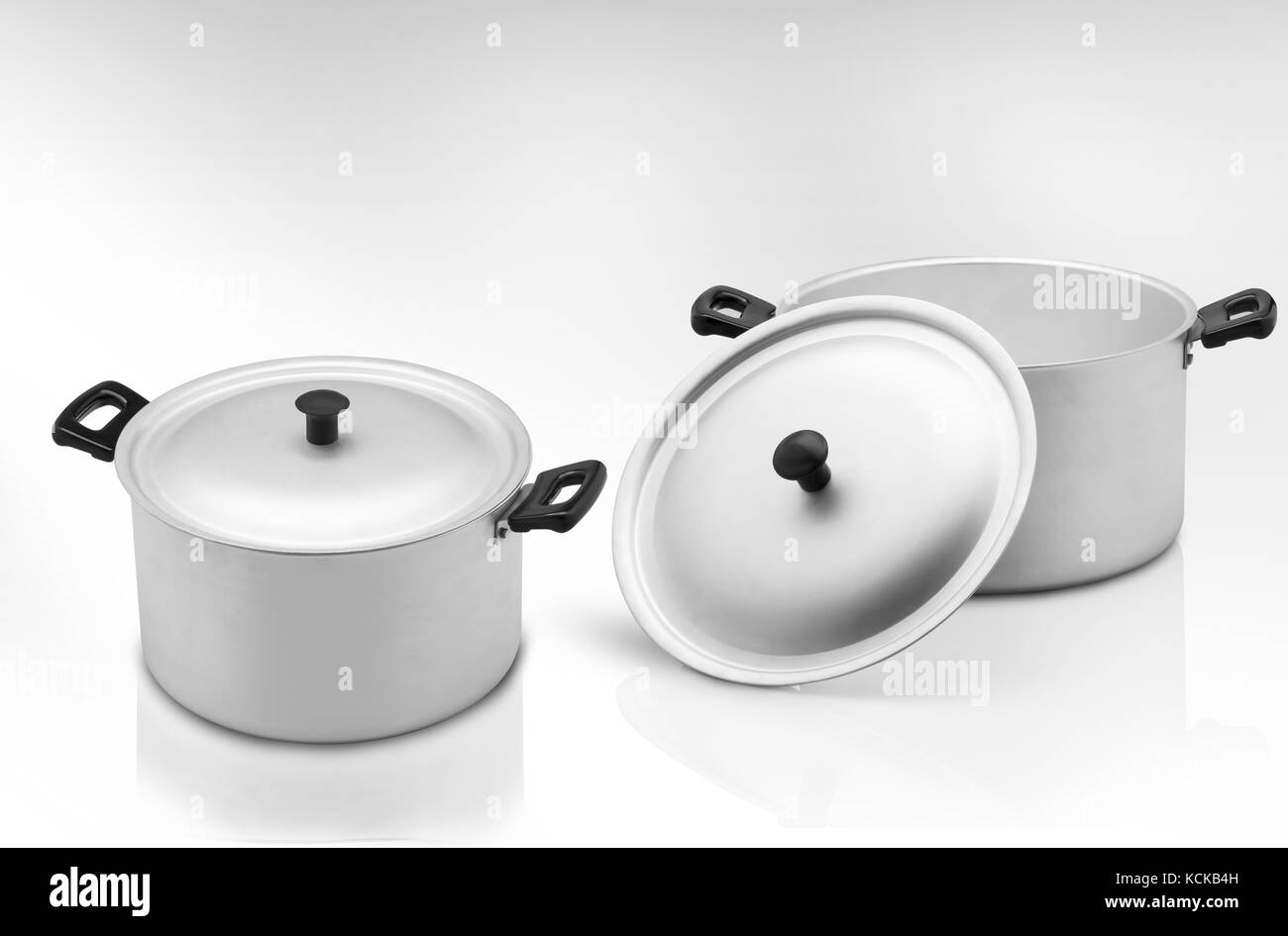 several cooking pots on a light background Stock Photo - Alamy