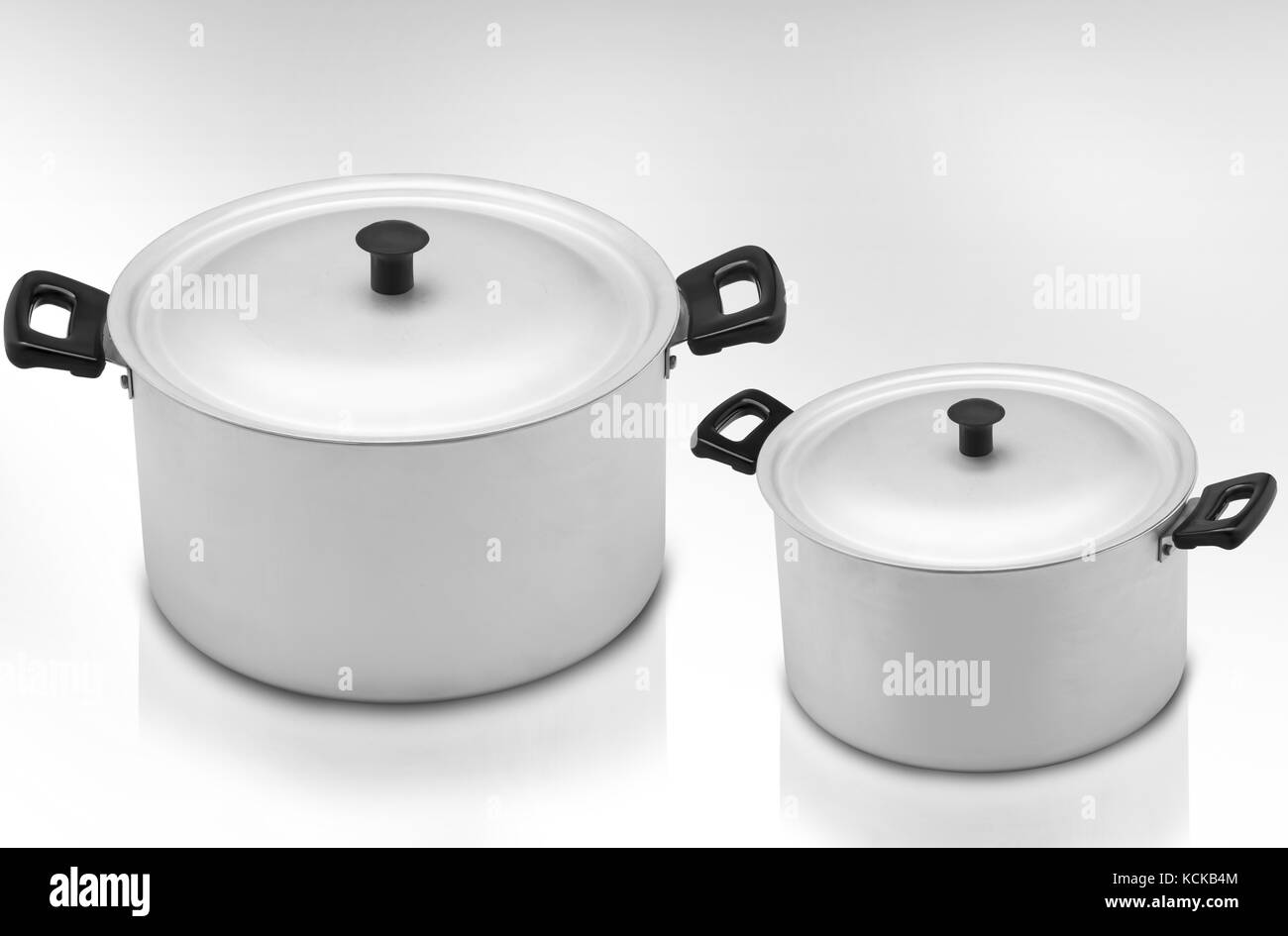 several cooking pots on a light background Stock Photo - Alamy
