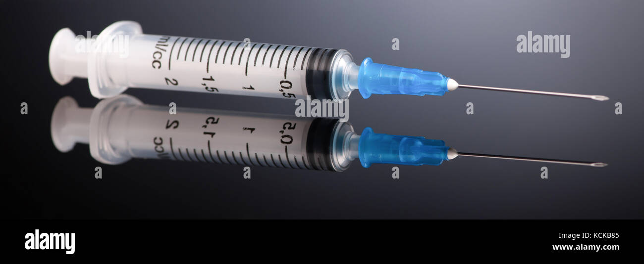 one medical syringe on a dark gray background with reflection Stock ...