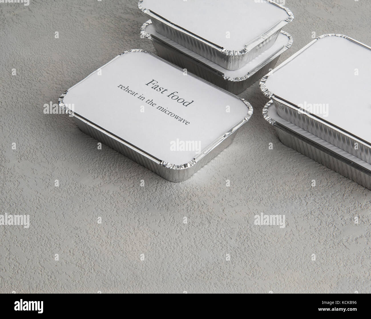 set of fast food in a box of foil on a gray rough background. food for ...